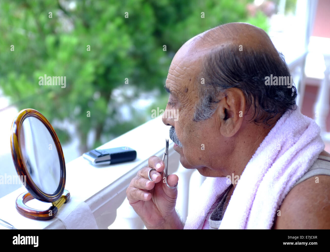 Elderly man cutting his mustache Stock Photo - Alamy