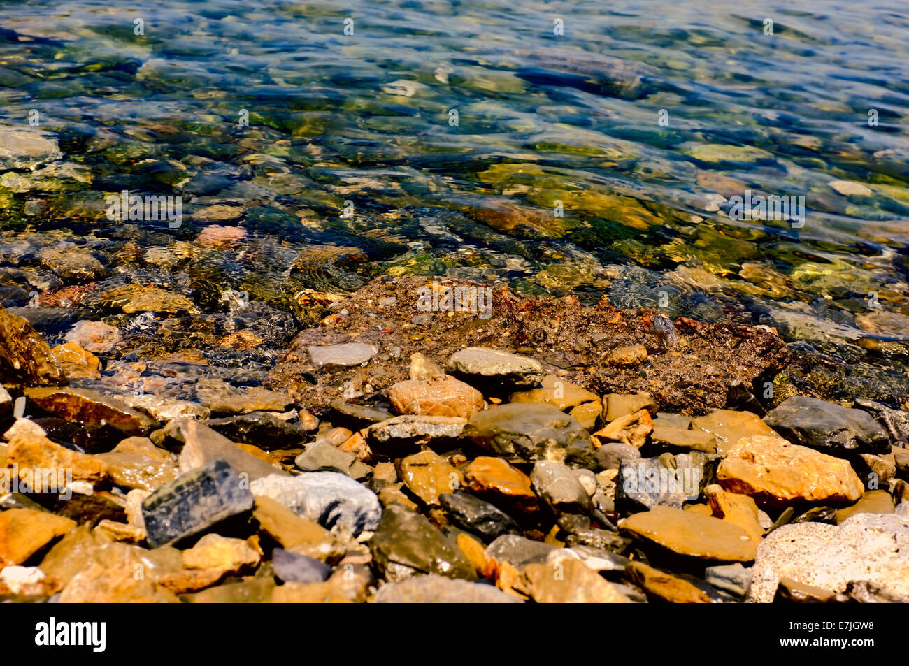 Shallow water with stones inside Stock Photo - Alamy