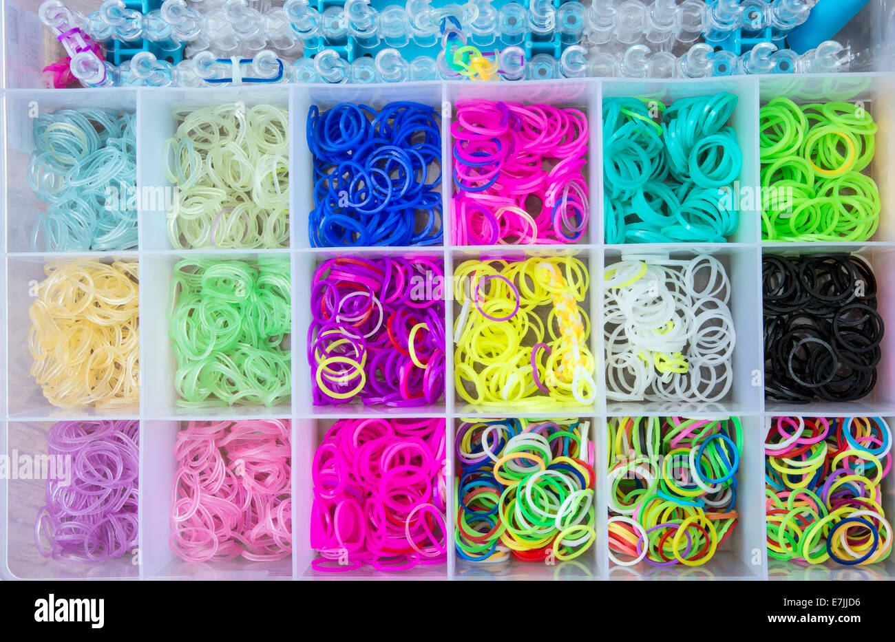 Big box with colorful rubber bands for rainbow loom. Handiwork theme ...