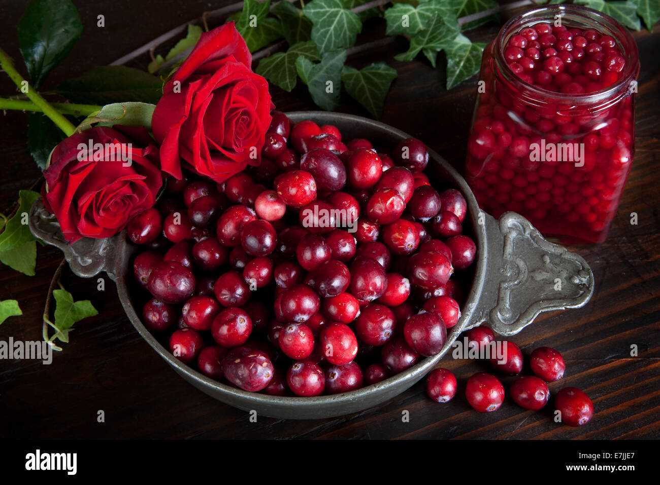 Thanksgiving still-life with cranberries and red roses Stock Photo - Alamy