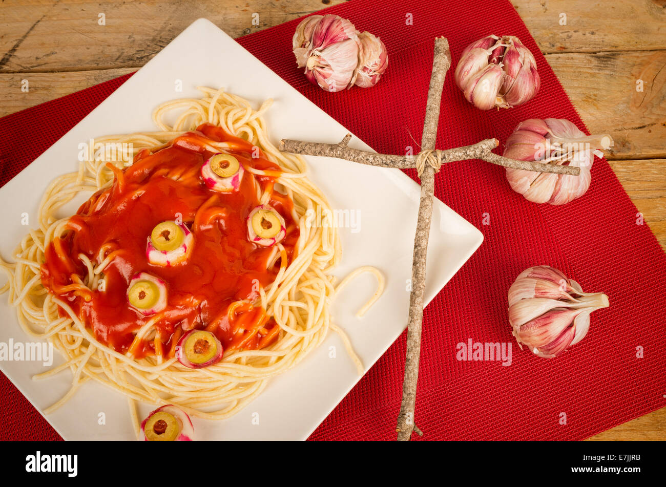 Portion of Halloween spaghetti with spooky eyes, a cross and garlic to ...