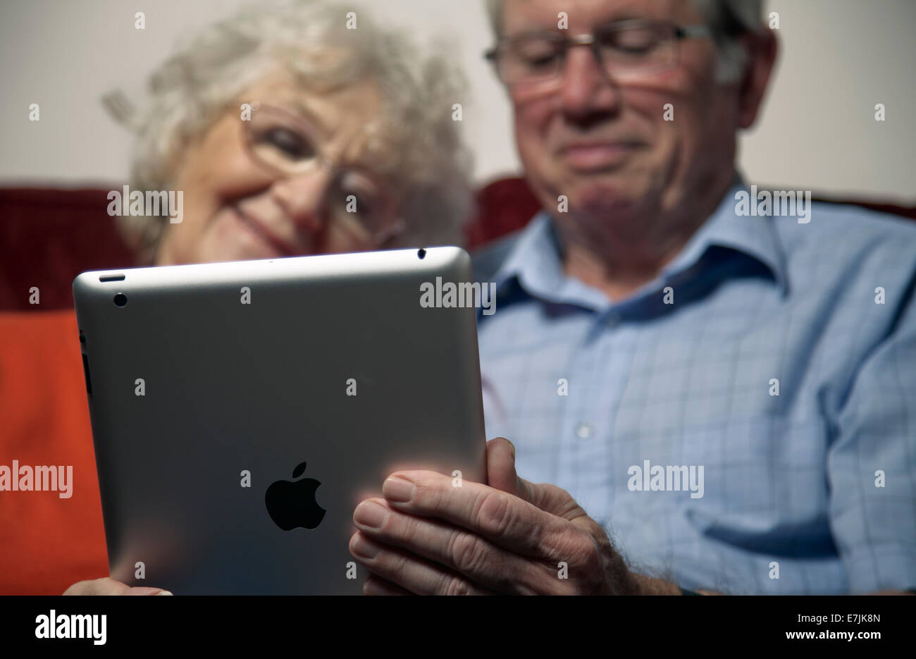 A senior couple enjoying using an ipad at home Stock Photo - Alamy