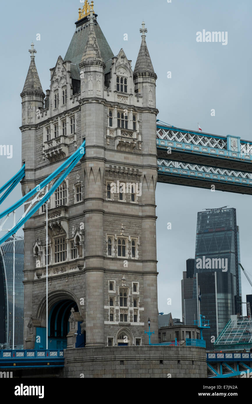 One side of Tower bridge on an overcast day with the London skyline ...