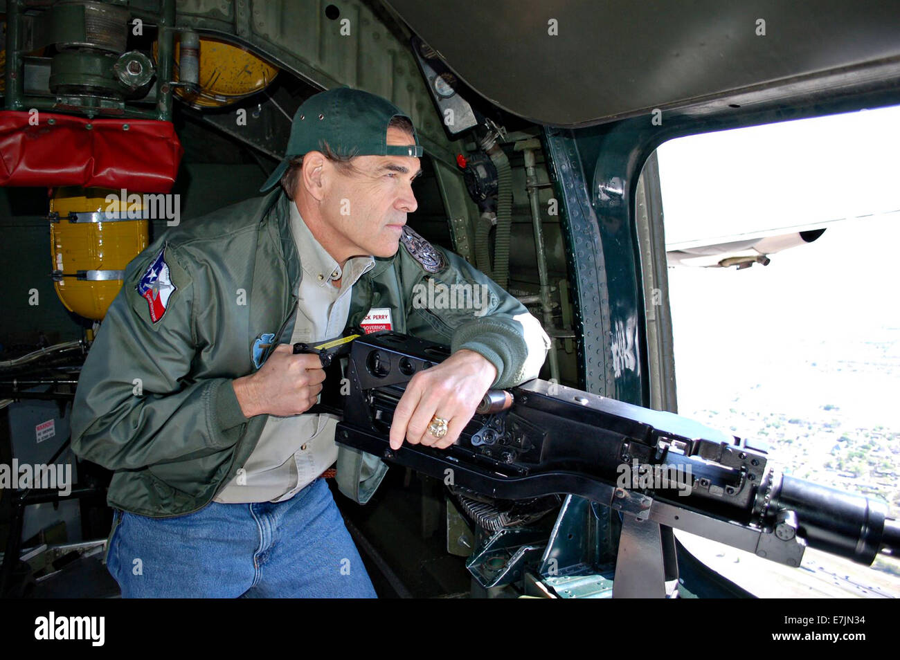 Texas Governor Rick Perry mans a machine gun in the open doorway of the ...