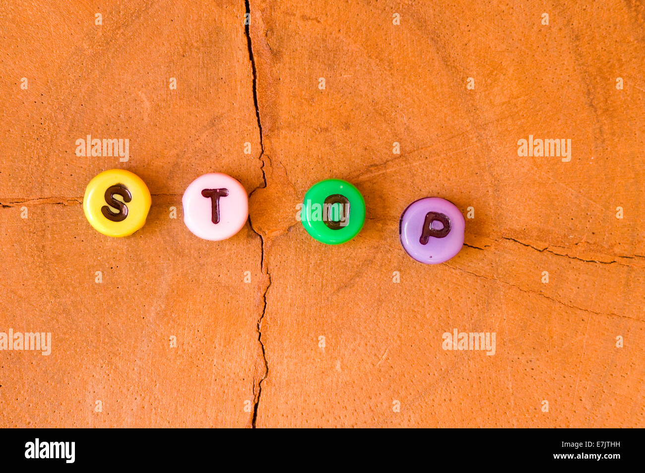 word stop written with colorful letters on elegant wood background ...