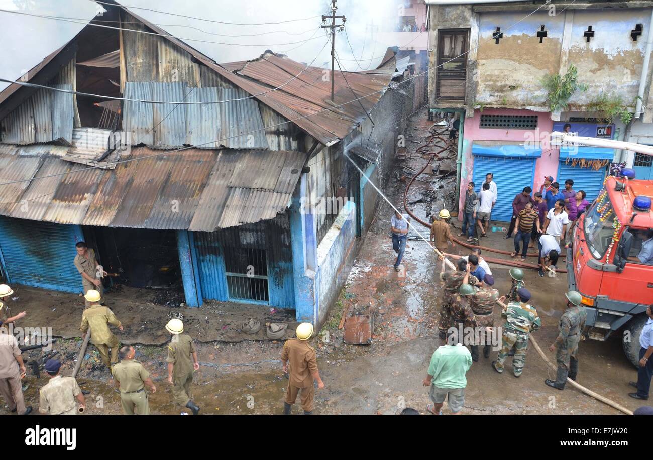 Nagaland, India. 19th Sep, 2014. Indian firefighters try to extinguish ...