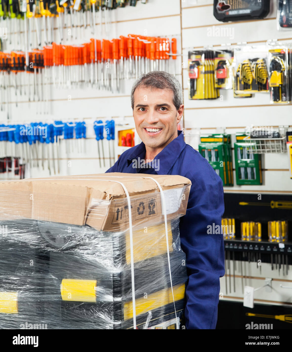 Worker With Tool Package In Hardware Shop Stock Photo - Alamy