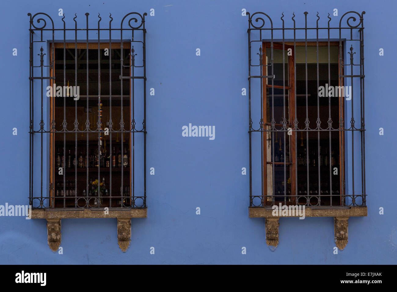 Windows on a blue wall in Antigua, Guatemala Stock Photo - Alamy
