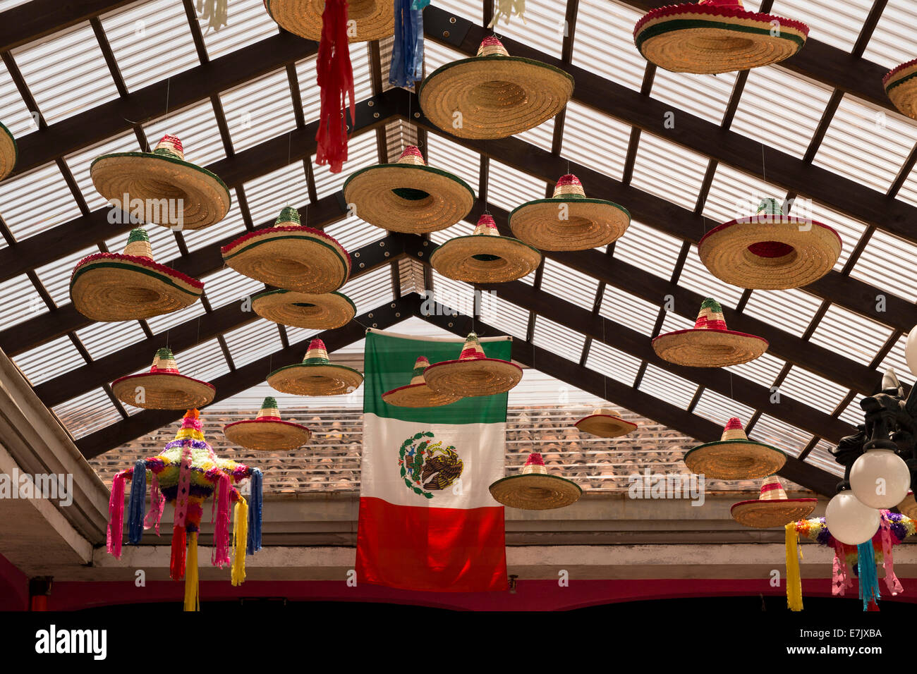 Mexican sombreros hanging down a glass roof in a restaurant of Antigua ...