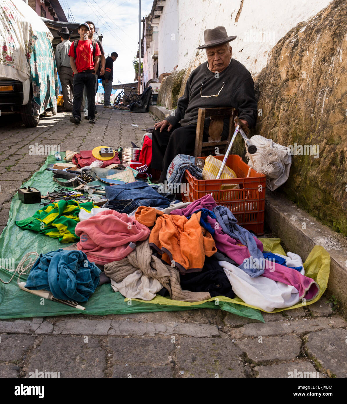 Man selling clothes and used gear in Chichicastenango market, Guatemala ...