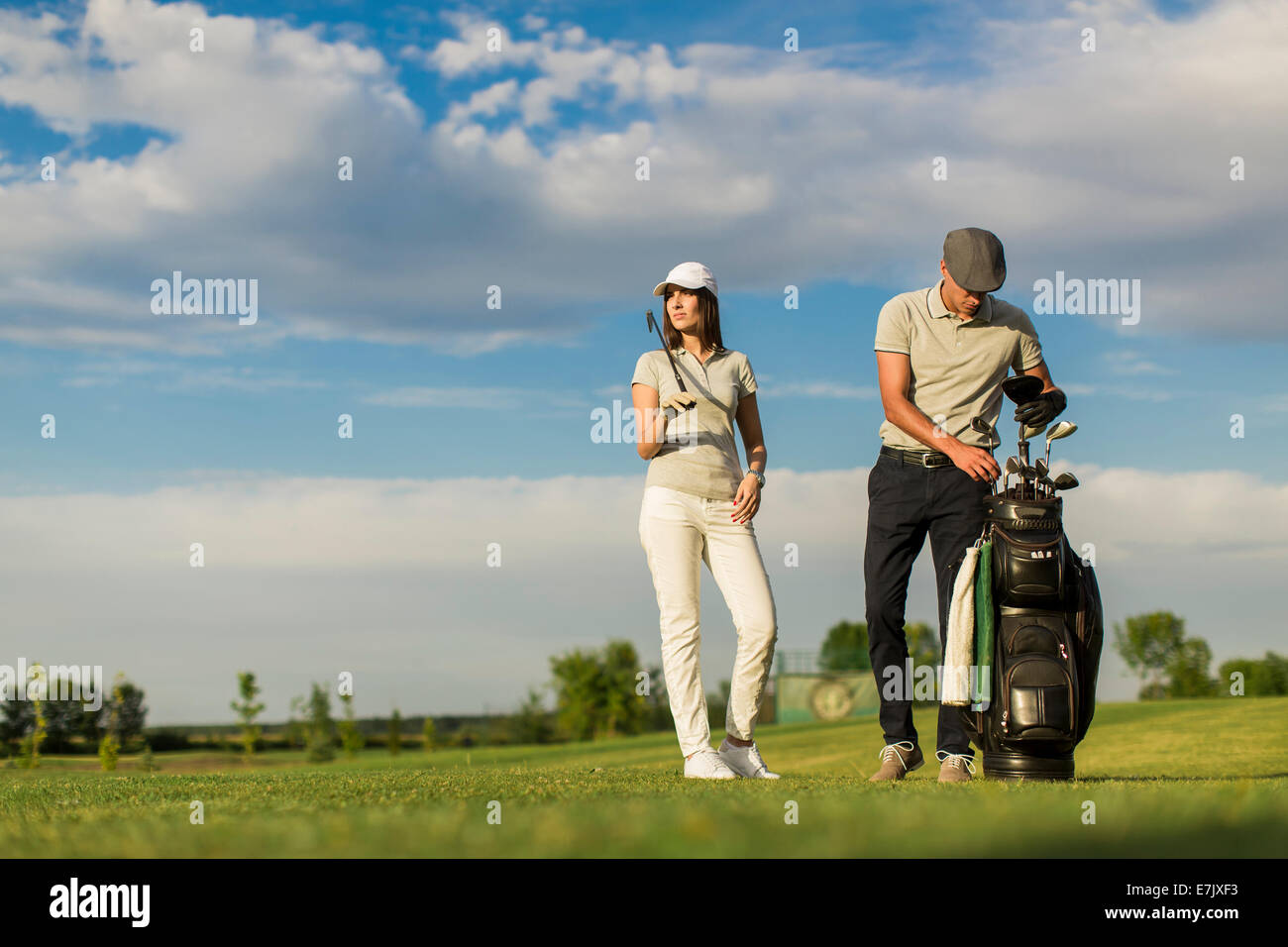 Young couple playing golf Stock Photo - Alamy