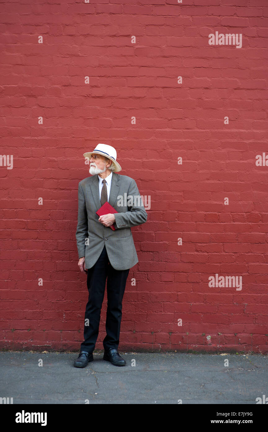 Red brick wall man standing hi-res stock photography and images - Alamy