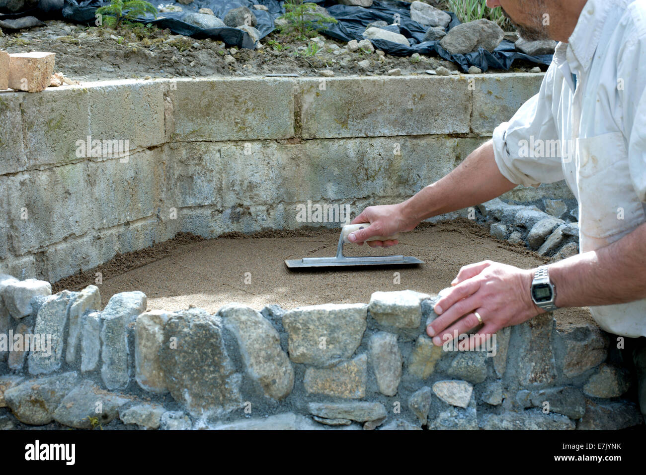 Earth cob clay oven project. The dry stone wall base has been topped ...