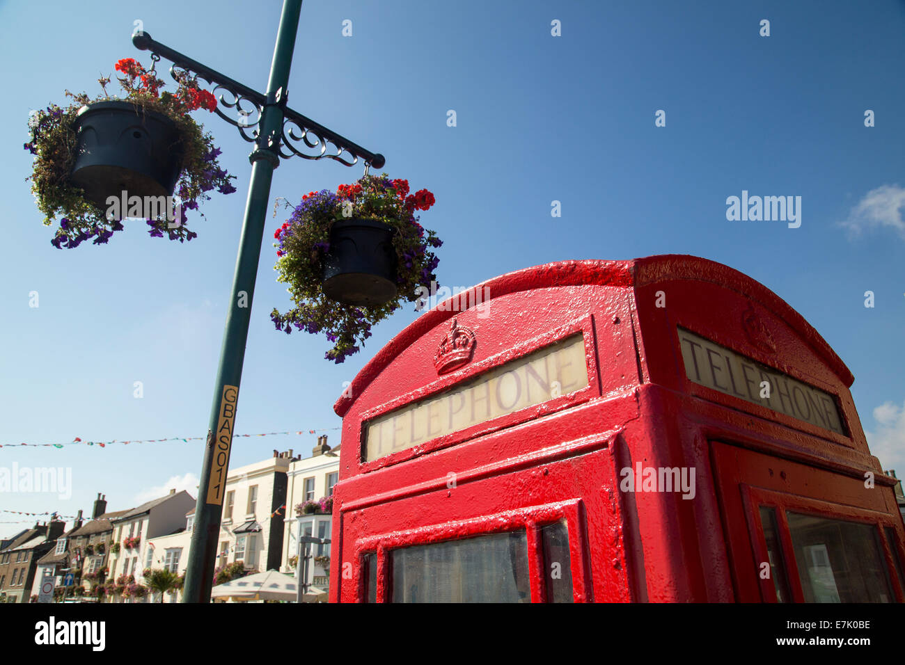 Classic old English red telephone call box sunshine Stock Photo - Alamy
