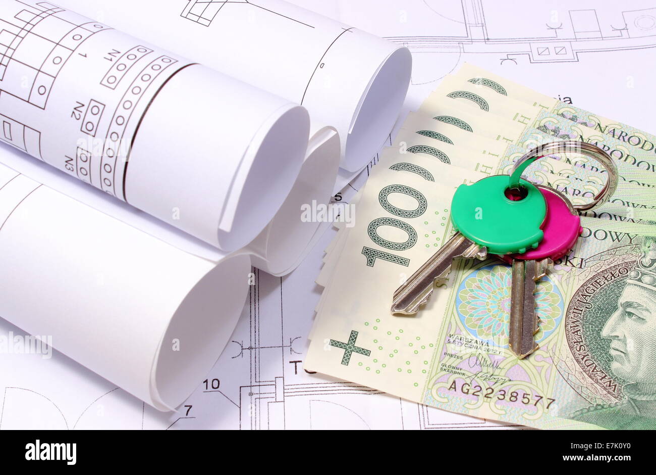 Rolled electrical diagrams on construction drawing of house and heap of ...