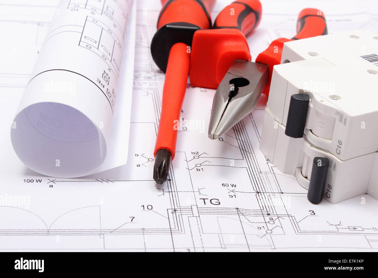 Rolled electrical diagrams, electric fuse and work tools lying on ...