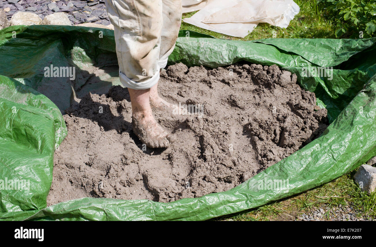 Preparatory work for building an earth oven. Mixing the clay for the ...