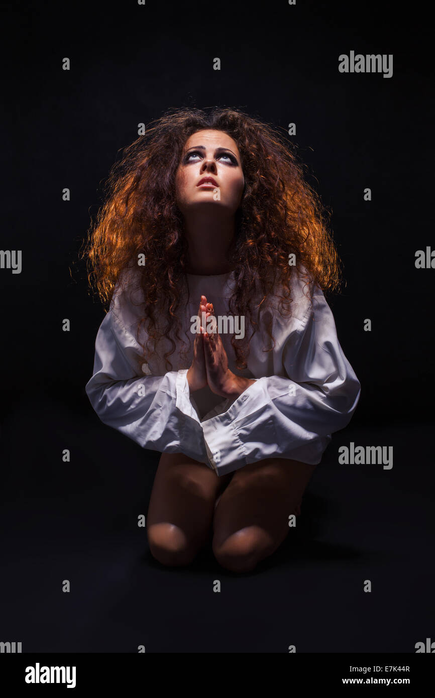 Woman Praying On Her Knees