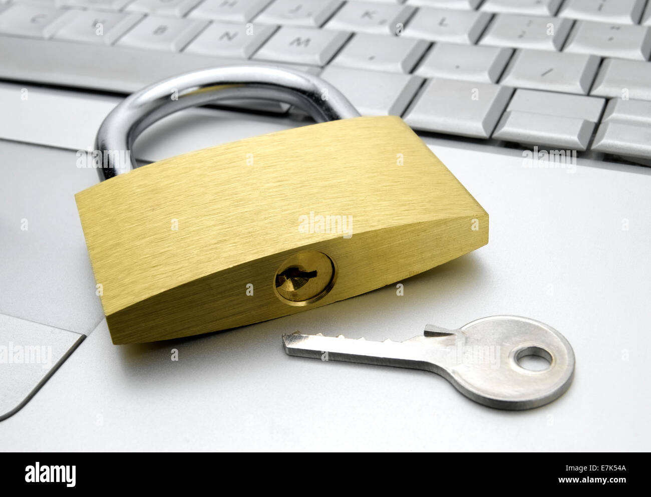Padlock on a silver laptop Stock Photo - Alamy