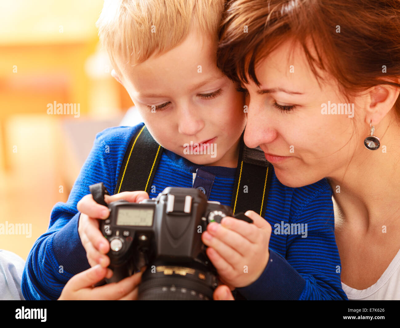 Happy childhood. Mother and her son boy child playing with camera ...