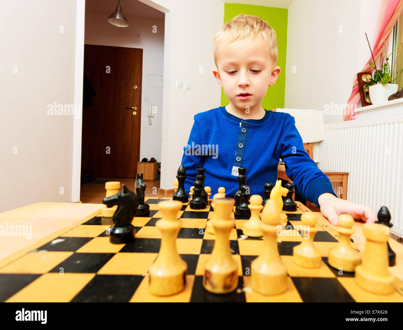 Little boy clever child kid playing chess thinking. Childhood and ...