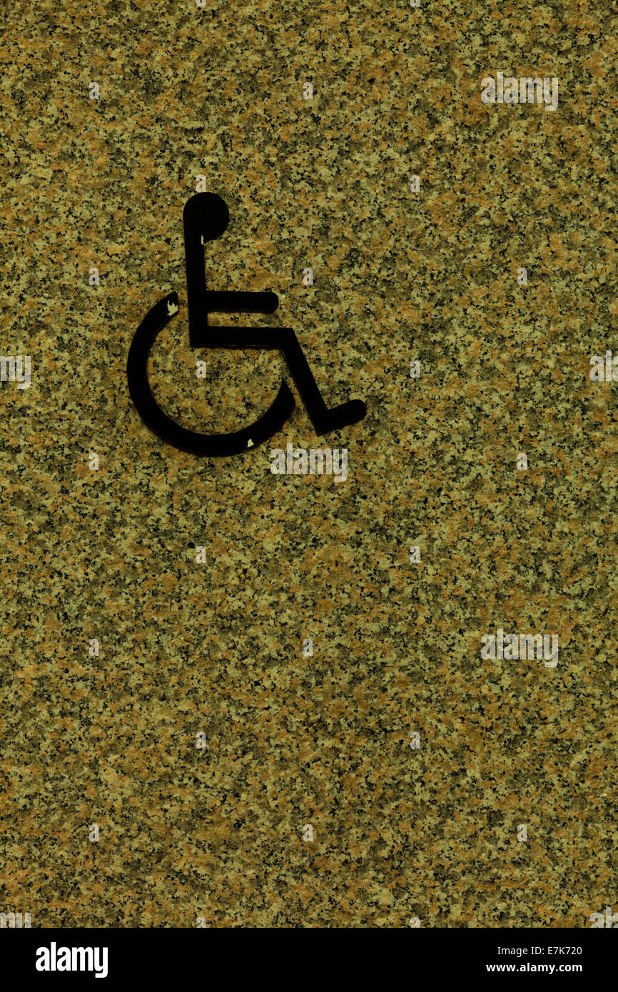 Handicapped sign on wall, detail of an information signal, disabled ...