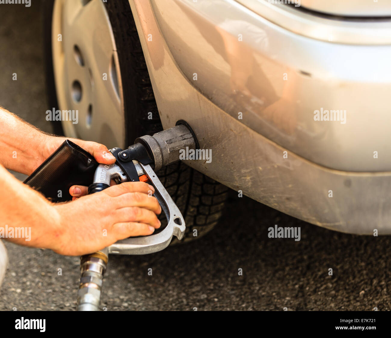 Auto refuel. Car at gas station being filled with fuel, fill up of ...