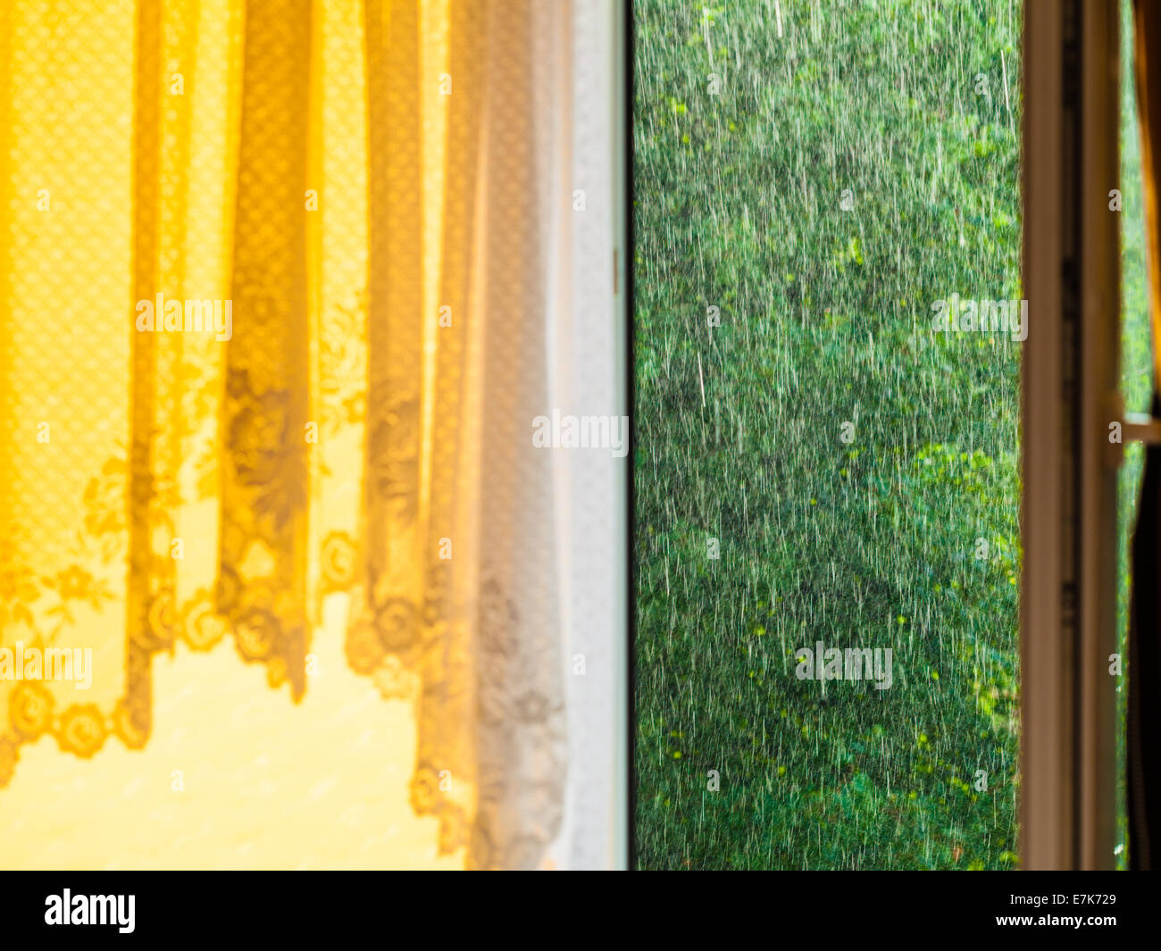 Summer rainy outside window, water drops droplets raindrops on glass windowpane. Downpour rain ...