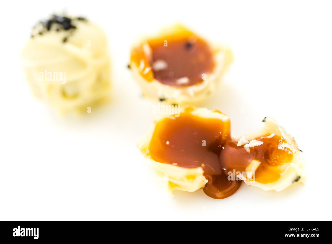 Gourmet white chocolate salted liquid caramel truffle on a white ...