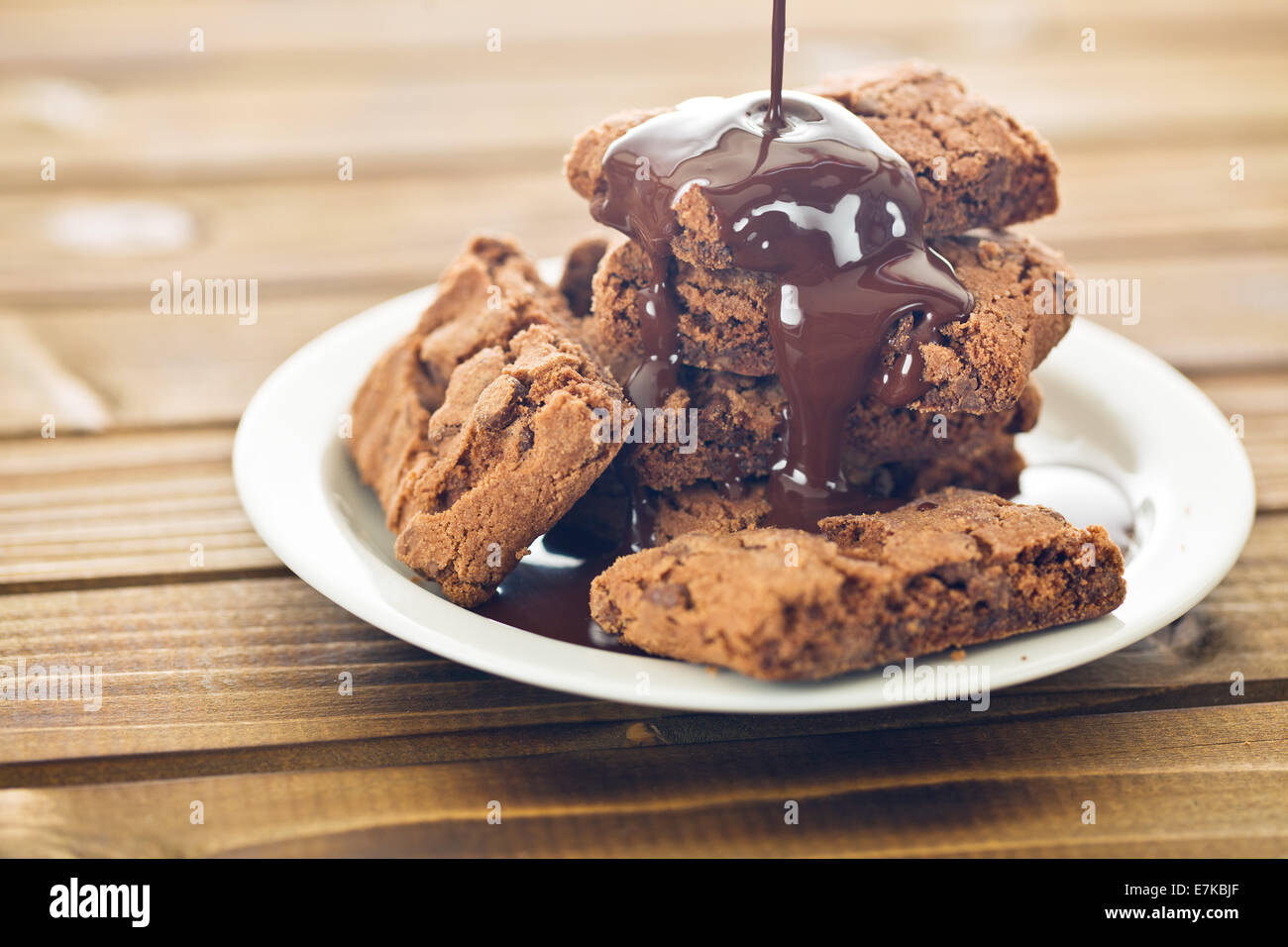 Pouring chocolate on sweet brownies Stock Photo - Alamy
