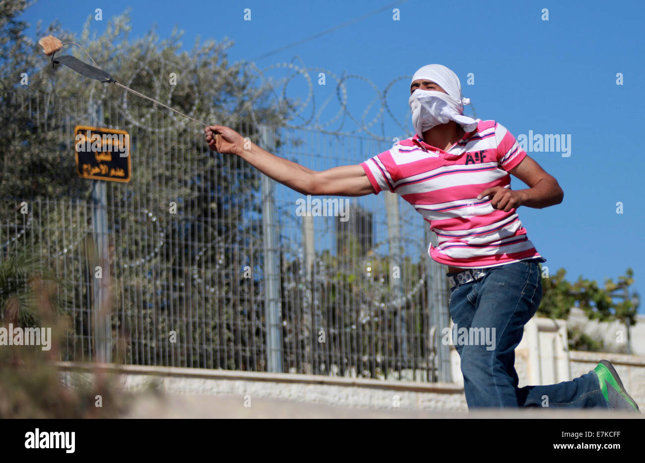 Silwad, West Bank. 19th Sep, 2014. A Palestinian protester uses a sling ...