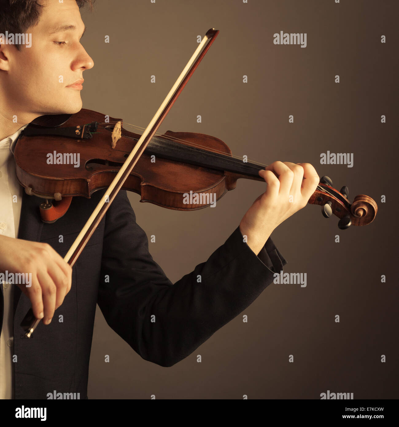 Art and artist. Young elegant man violinist fiddler playing violin on ...