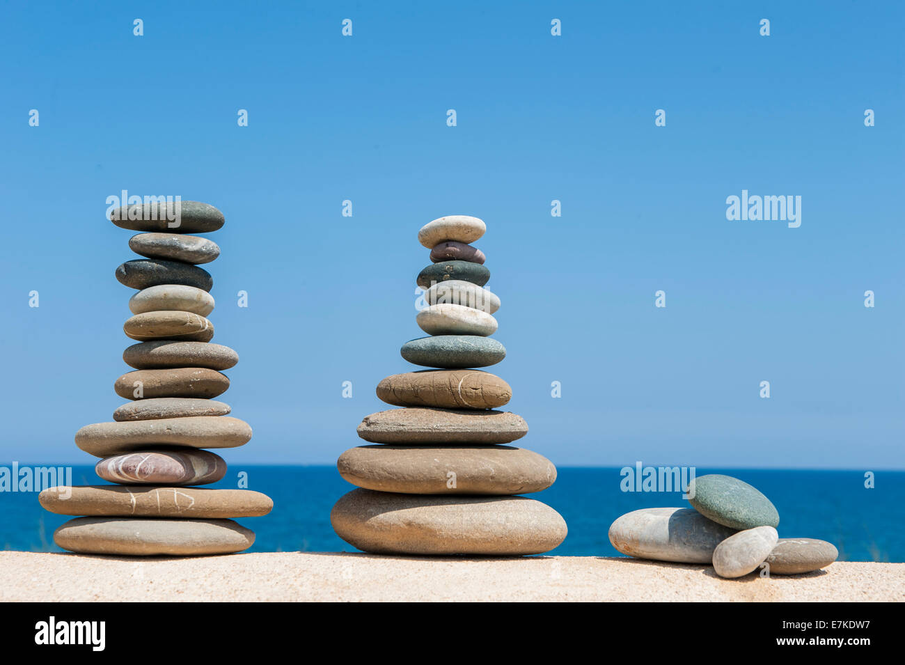 Two piles of pebbles on the coast with a blue sea Stock Photo - Alamy