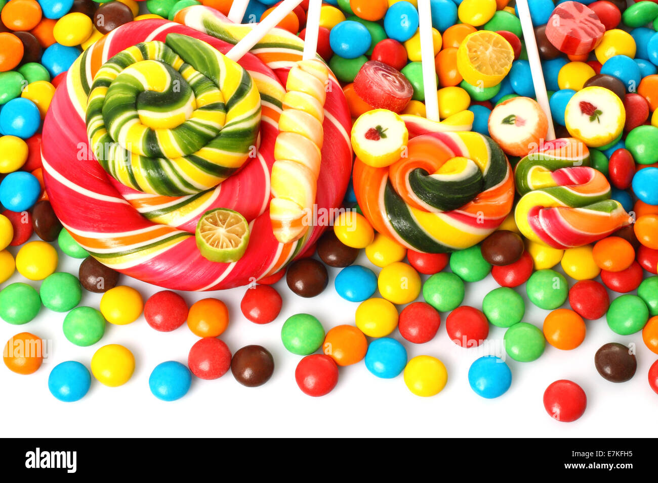 Colorful spiral lollipop with chocolate coated candy on white ...