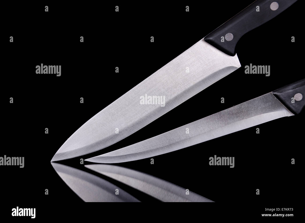 Close up view of two kitchen knives over black isolated background ...