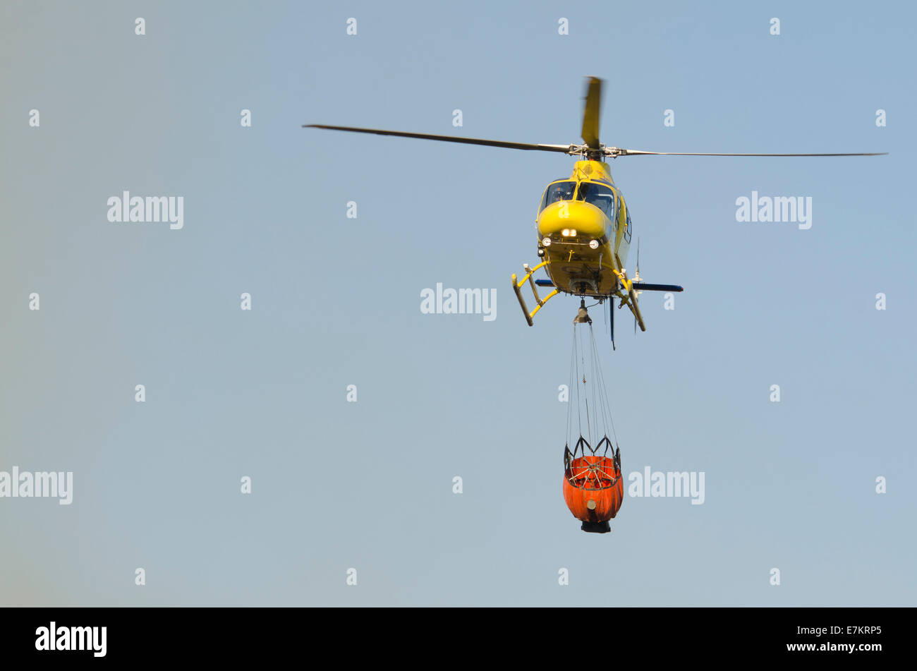 Aerial Firefighting with helicopter water bombing a bushfire near an ...