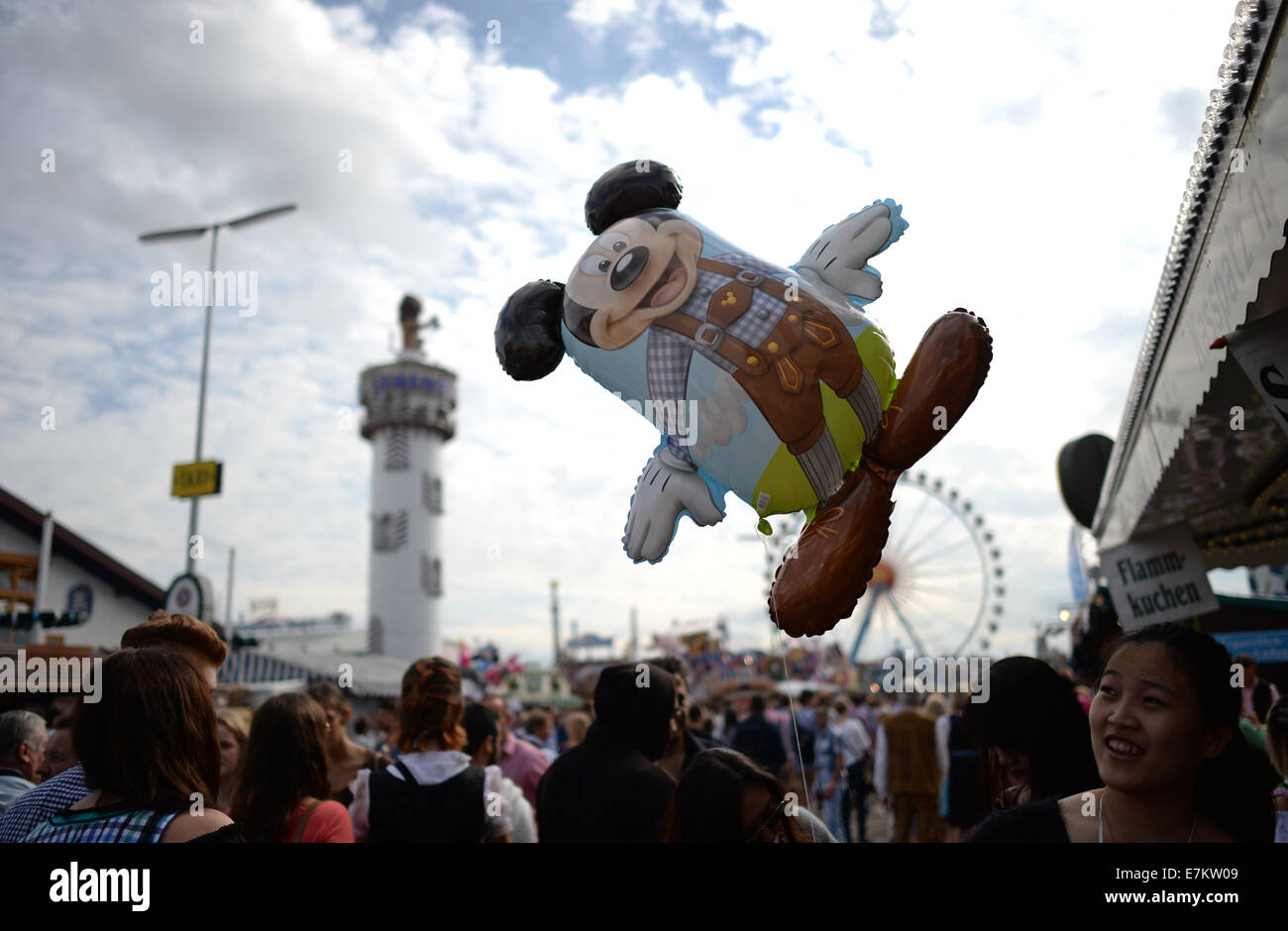 Munich, Germany. 20th Sep, 2014. A woman with a Mickey Mouse balloon ...