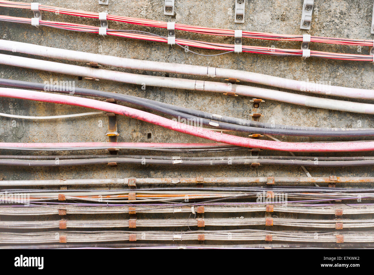 Electric cables against a stone wall as a background image Stock Photo ...