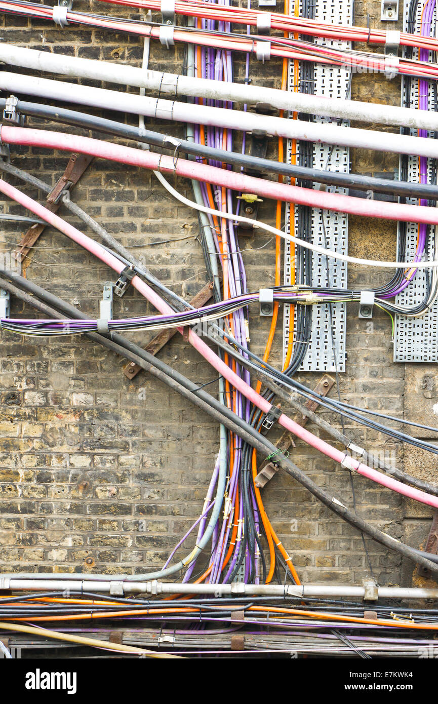 Electric cables against a stone wall as a background image Stock Photo ...
