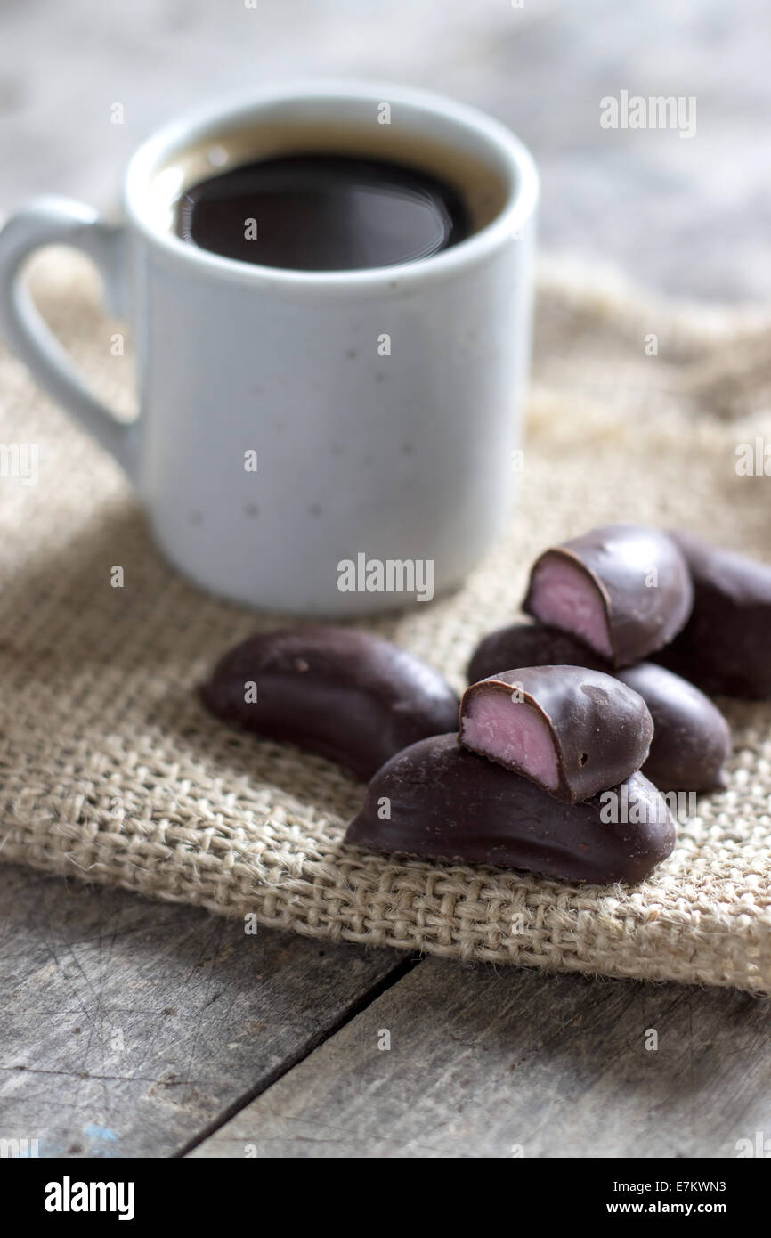 chocolate candies and cup of coffee, natural light Stock Photo - Alamy