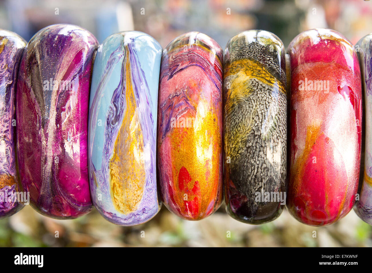 Row of colorful bangles on a rail Stock Photo - Alamy