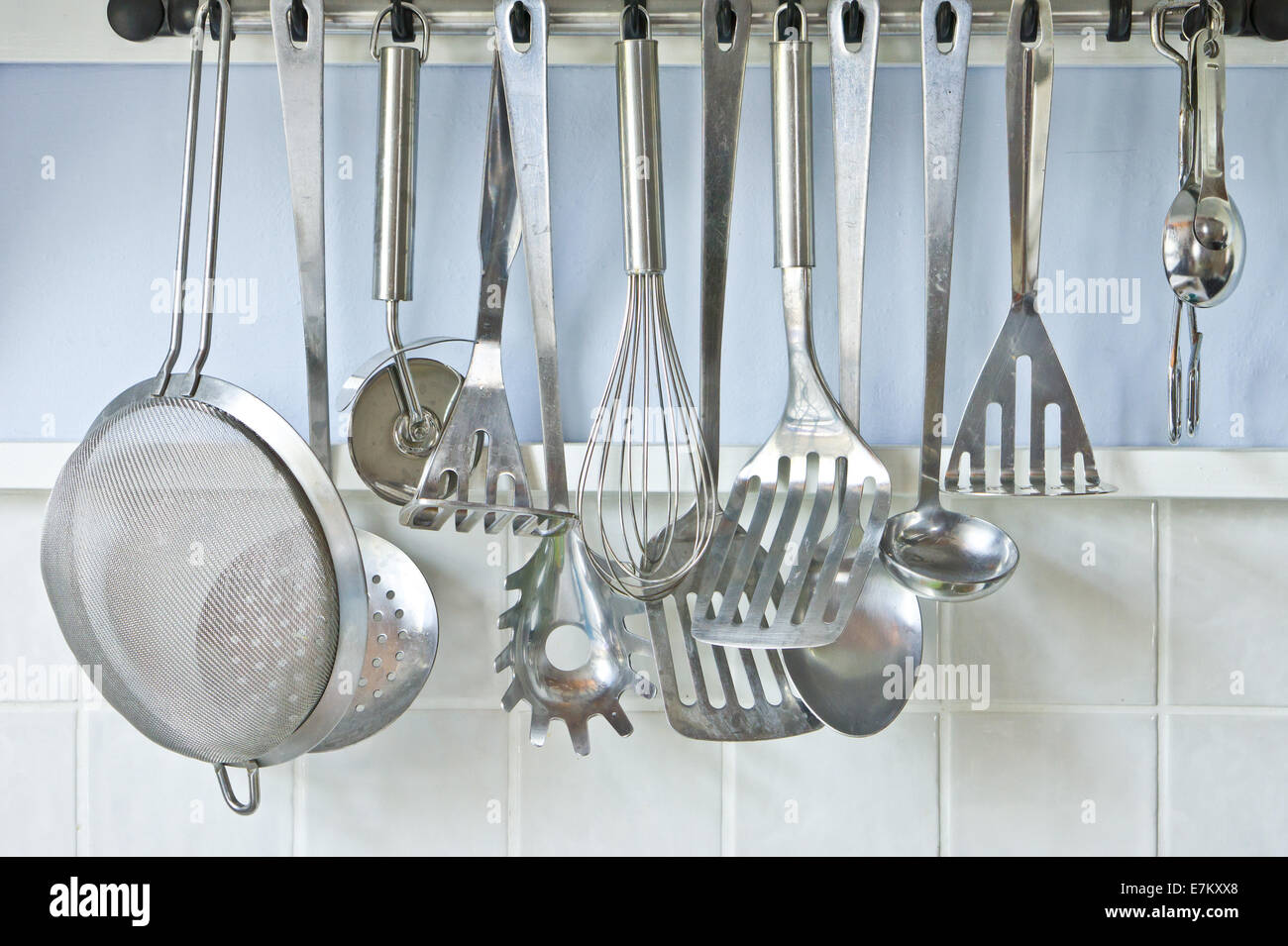 Kitchen utensils haning from a rack Stock Photo - Alamy