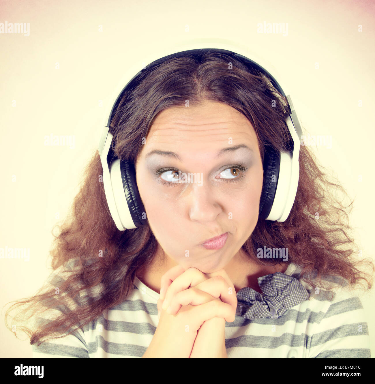 Portrait of female with suspicious expression and headphones Stock ...