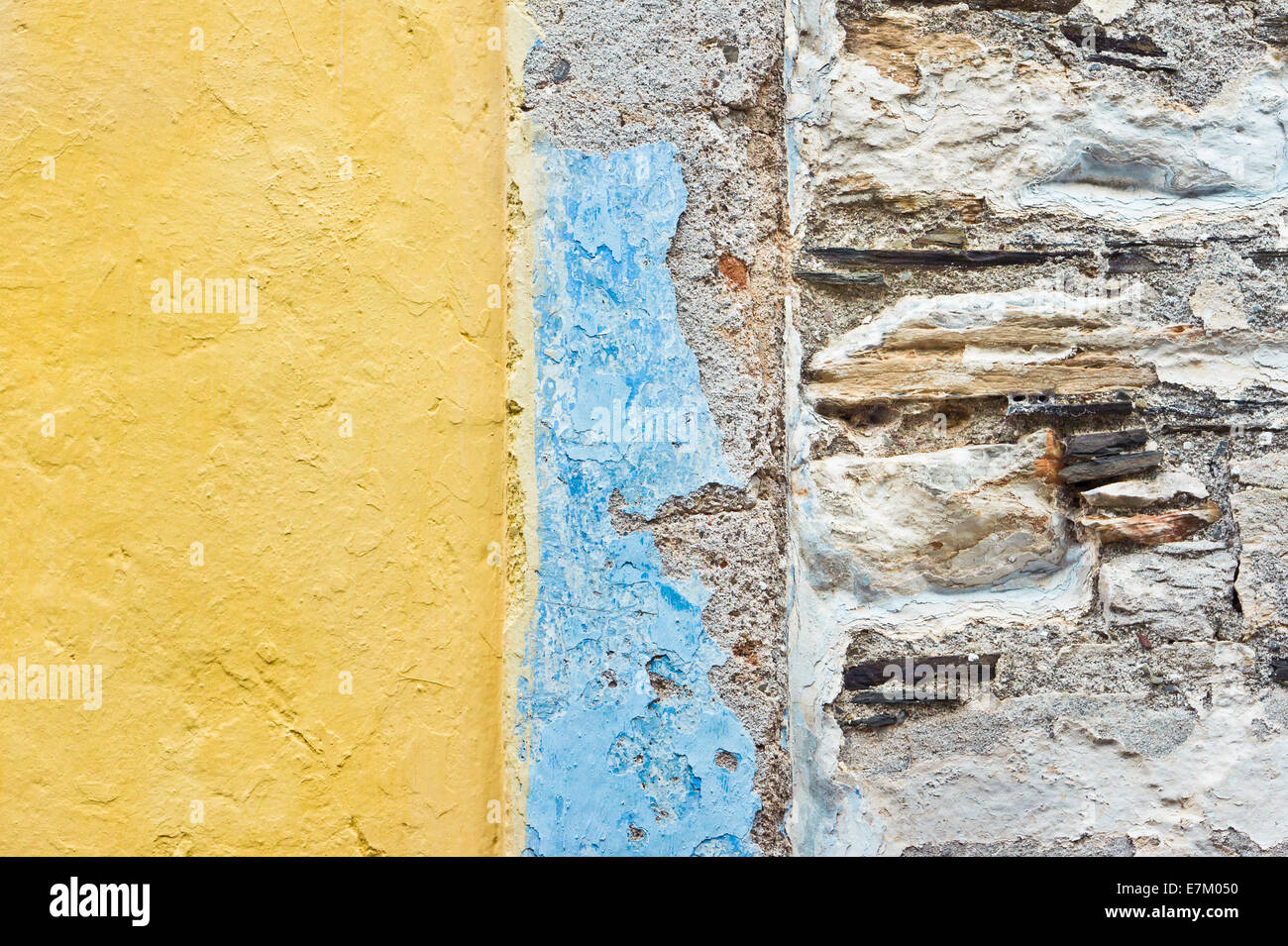 Yellow and blue pain on a stone wall as a background Stock Photo - Alamy