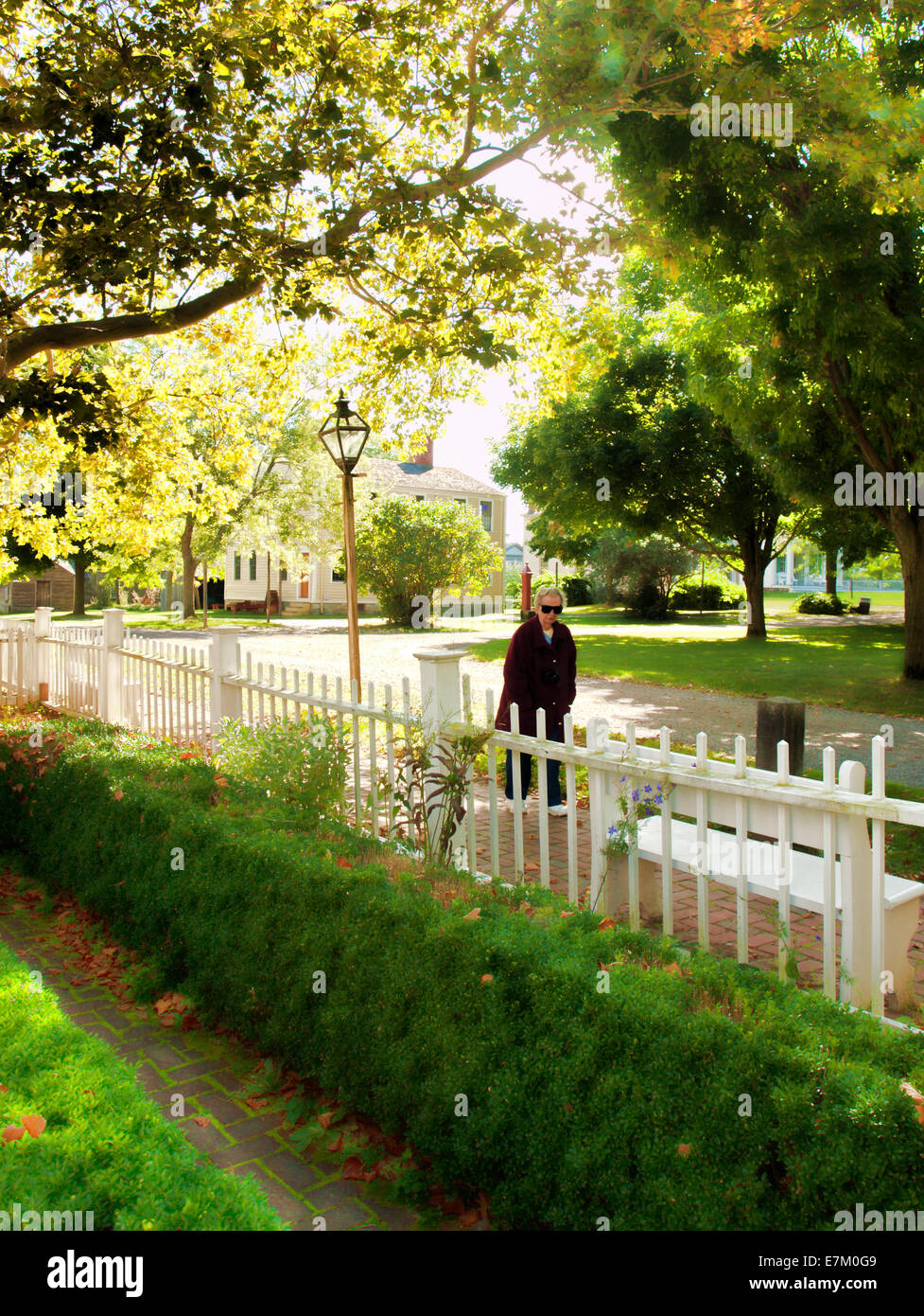 woman walking down quaint street in fall Stock Photo - Alamy