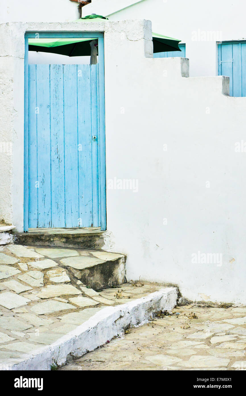 A blue wooden gateway in a whitewashed wall Stock Photo - Alamy