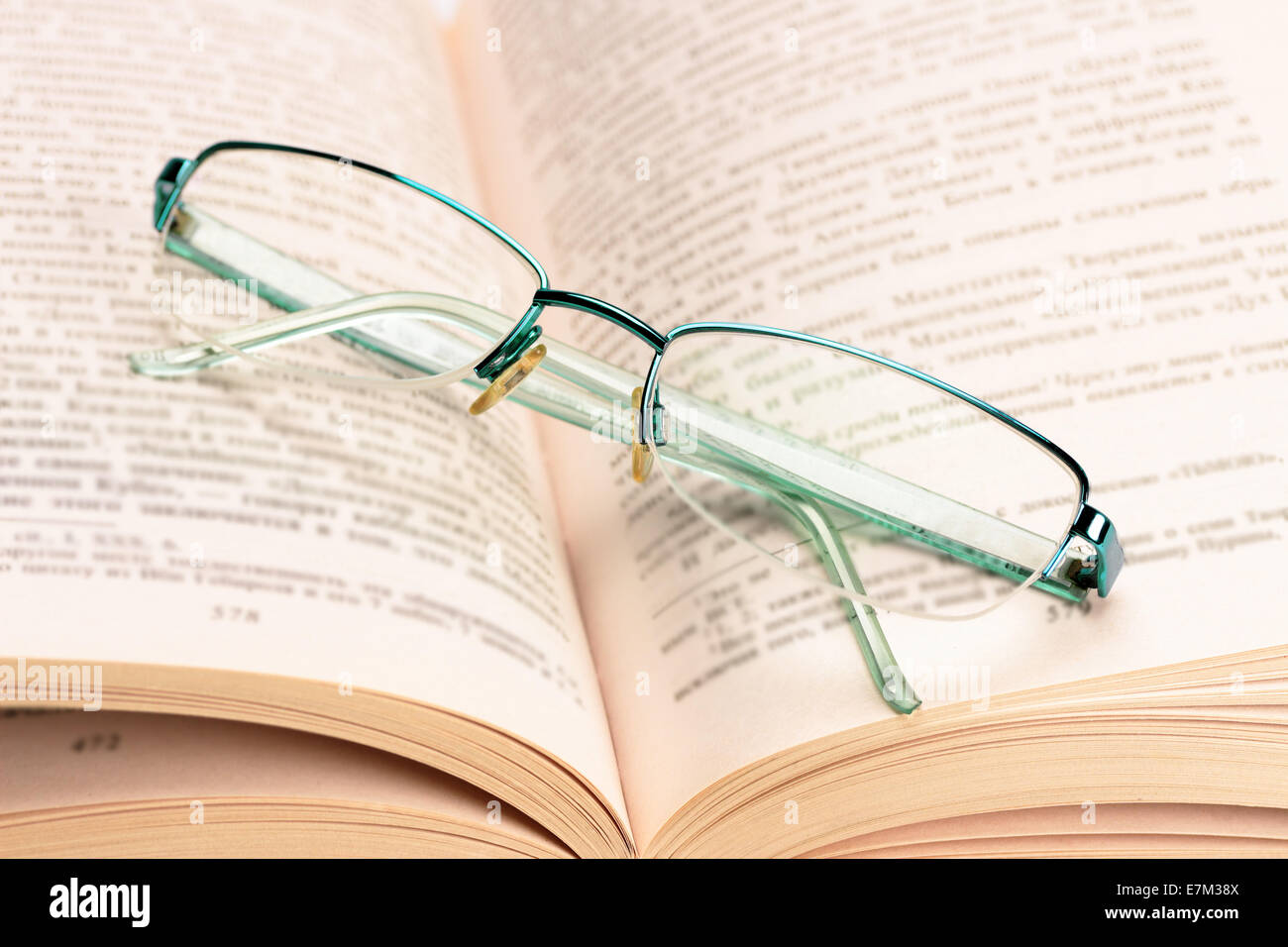 Isolated stack of books with glases Stock Photo - Alamy