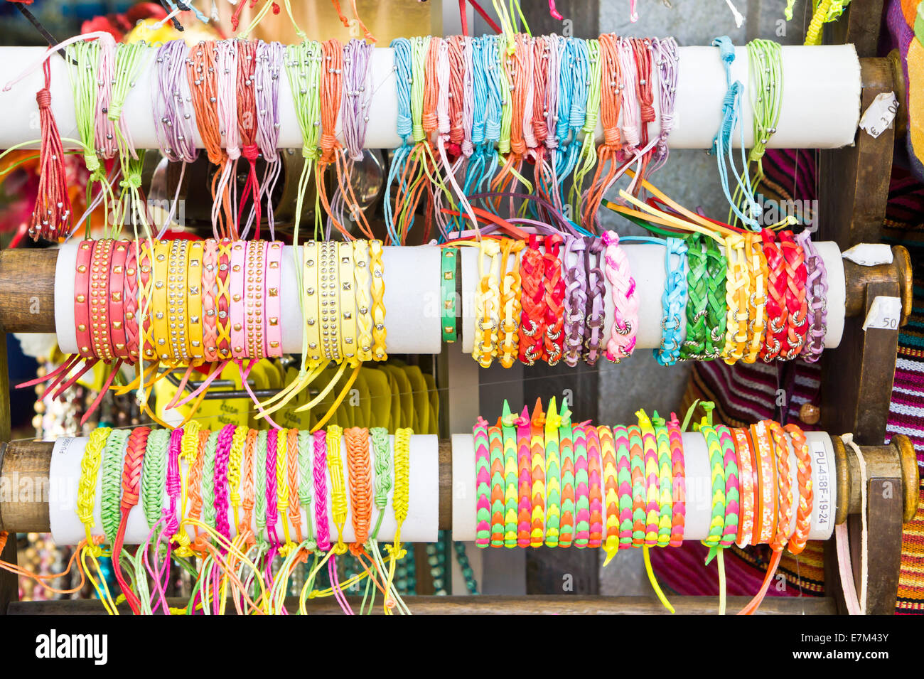 Colorful wristbands on display at a market Stock Photo - Alamy