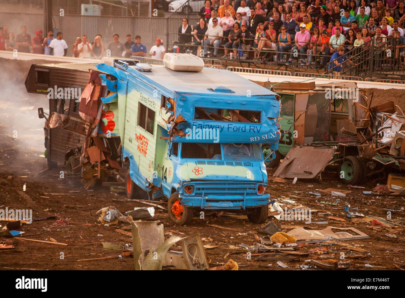 Brightly painted motor homes crash together in a demolition derby at ...