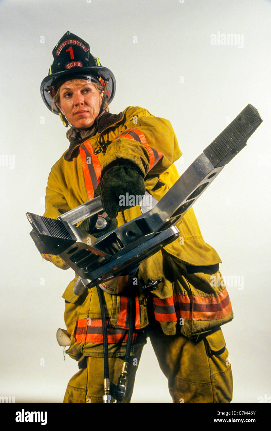 Wearing her safety helmet and coat, a San Diego, CA, woman firefighter ...